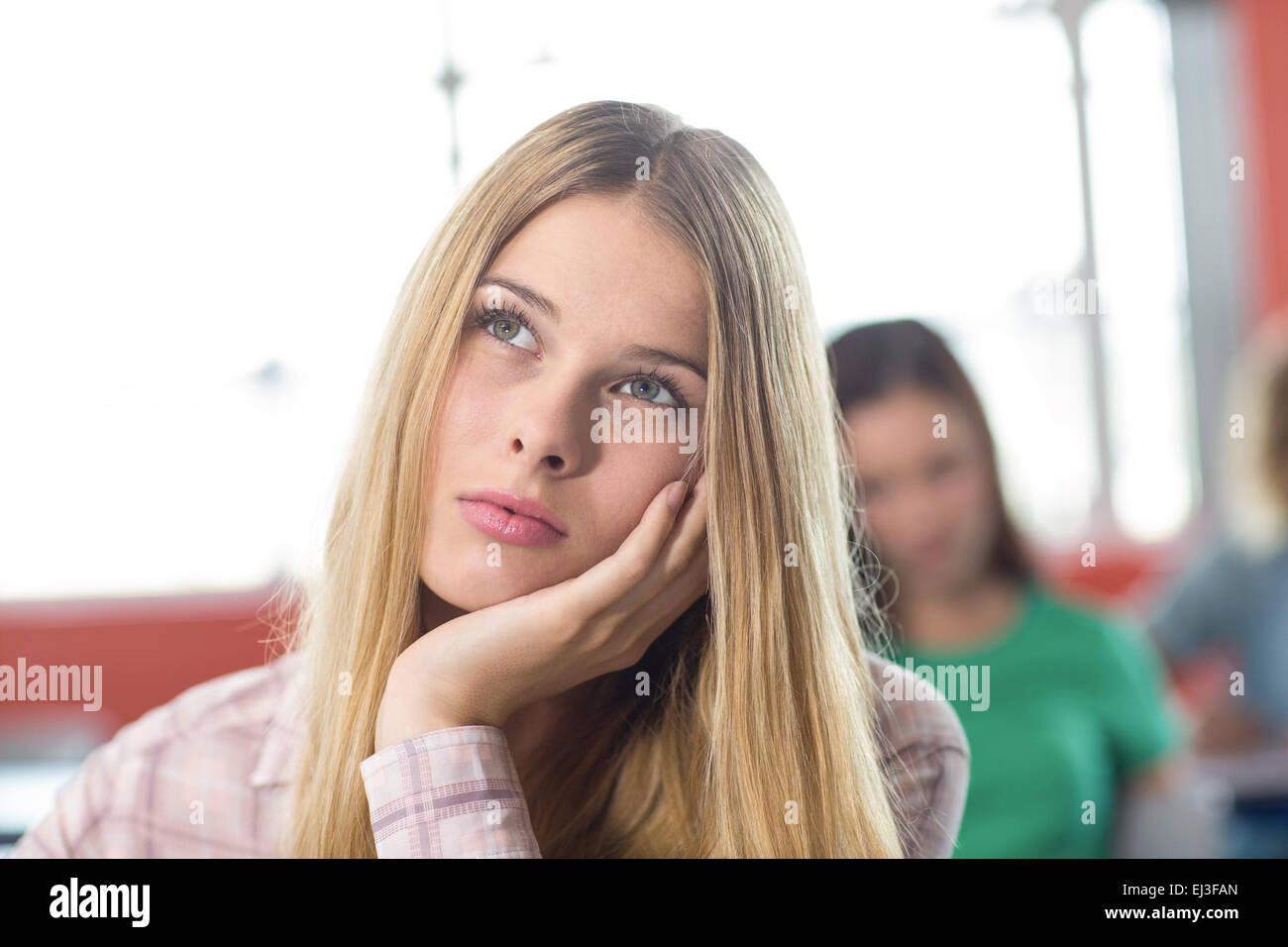 Thoughtful female student in classroom Stock Photo - Alamy
