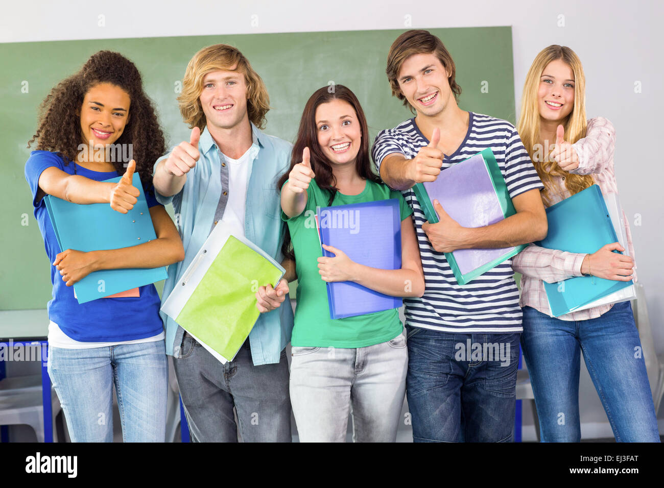 Happy college students gesturing thumbs up Stock Photo - Alamy