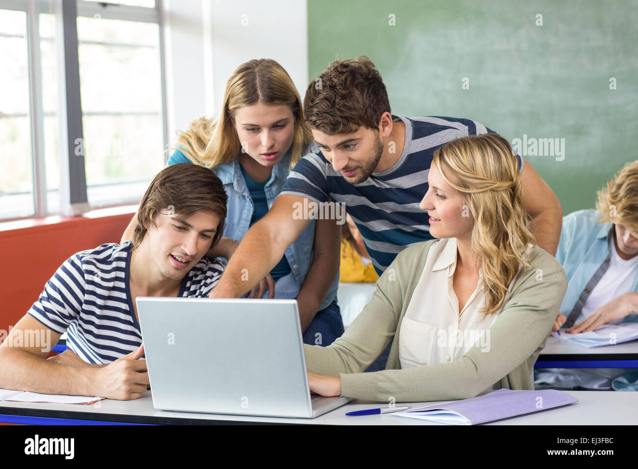 Students using laptop in classroom Stock Photo - Alamy