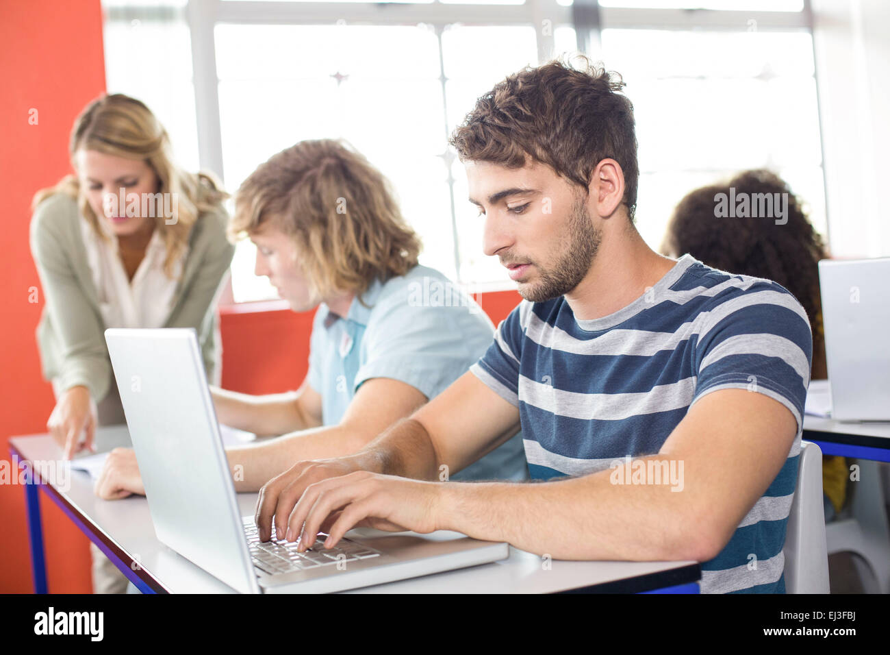 Student using laptop in classroom Stock Photo - Alamy