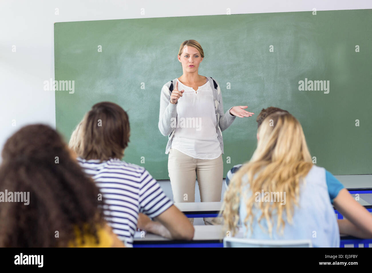 Teacher teaching students in class Stock Photo - Alamy