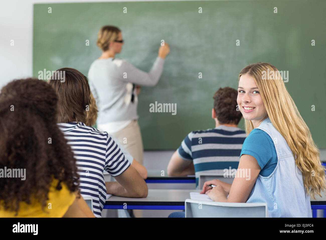 Teacher teaching students in class Stock Photo - Alamy