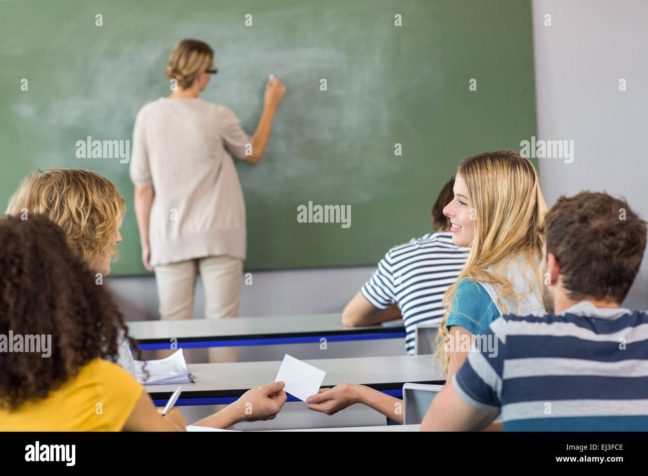 Teacher teaching students in class Stock Photo - Alamy
