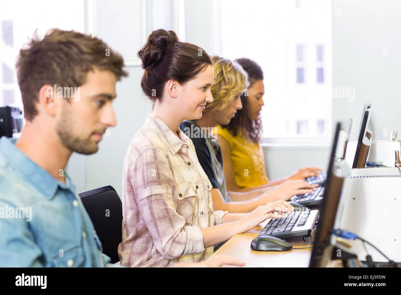 Side view of students in computer class Stock Photo - Alamy