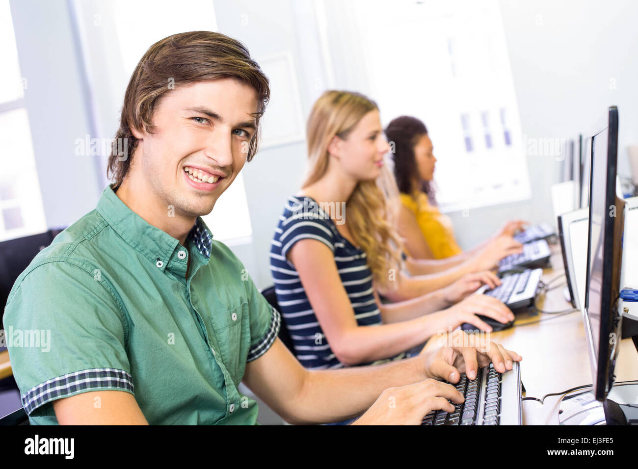 Side view of students in computer class Stock Photo - Alamy