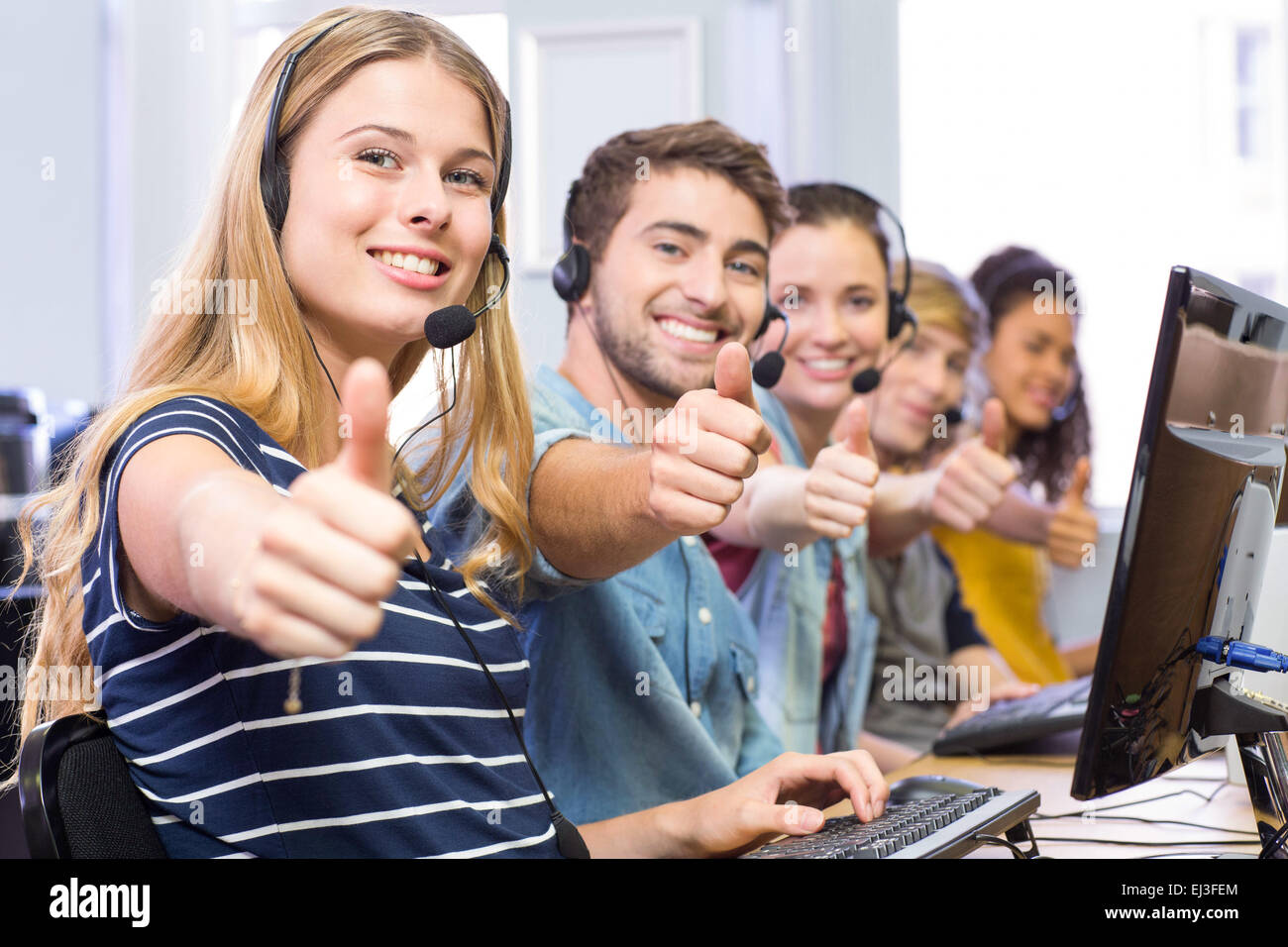 Students gesturing thumbs up in computer class Stock Photo - Alamy
