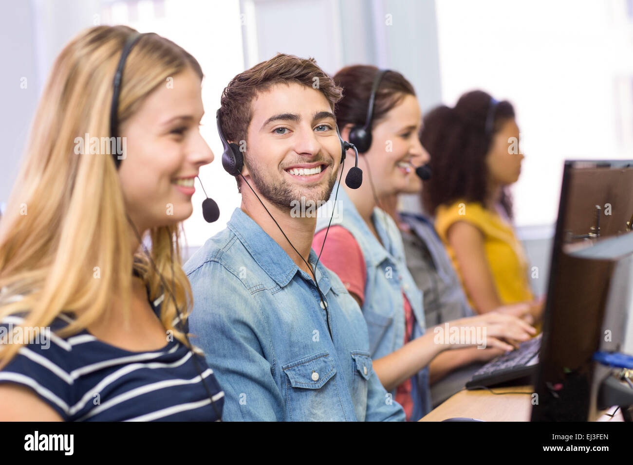 Students using headsets in computer class Stock Photo - Alamy