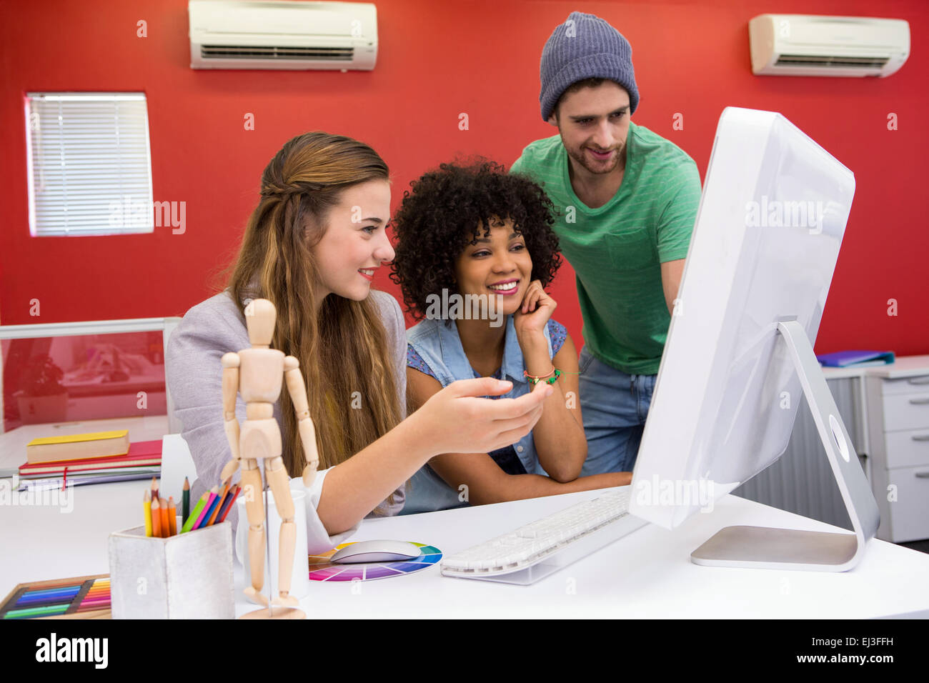 Team working at desk with colour samples Stock Photo - Alamy