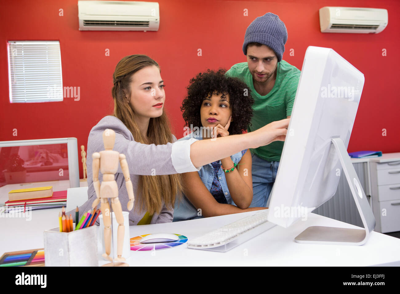 Team working at desk with colour samples Stock Photo - Alamy