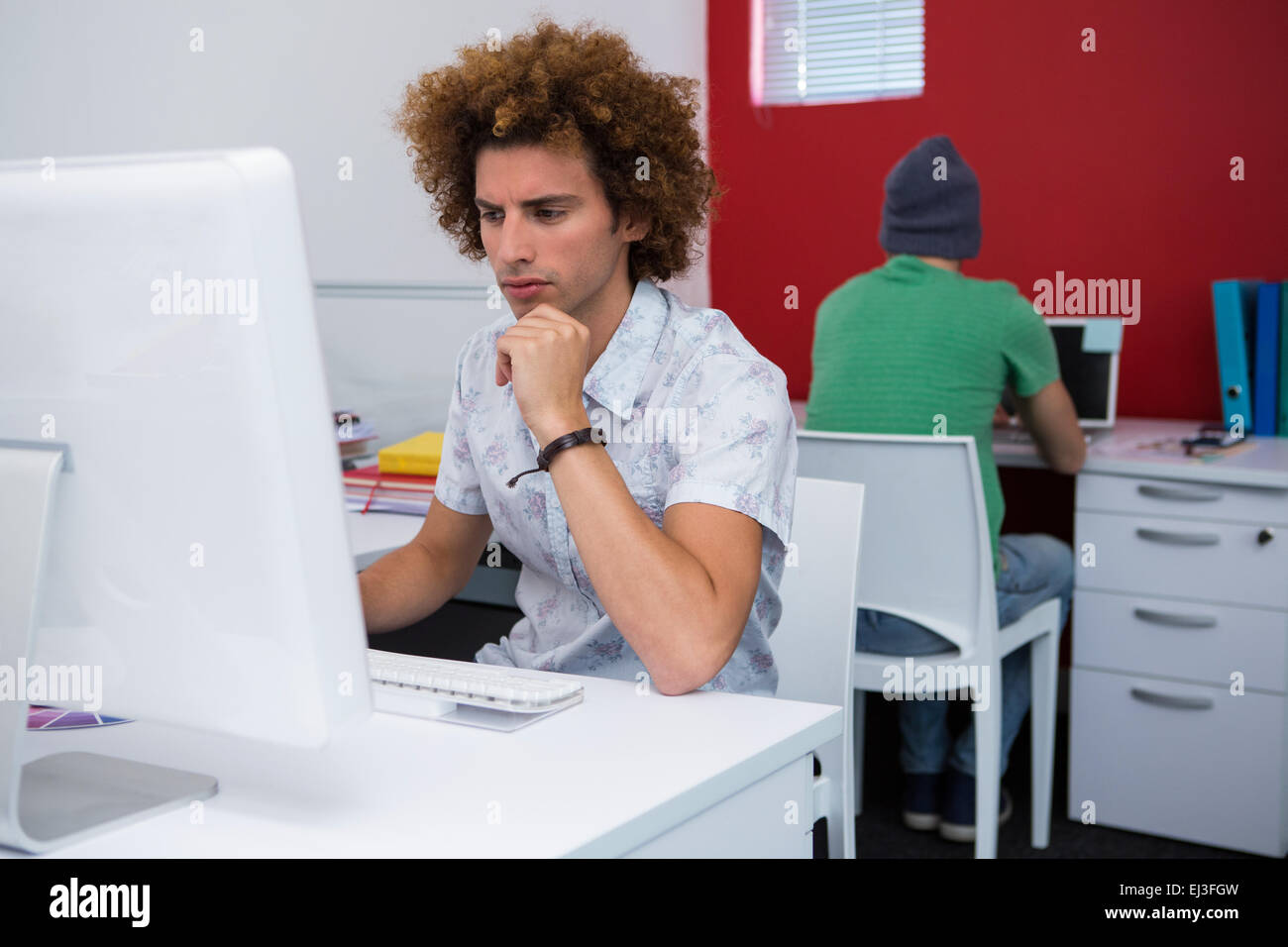 Concentrated casual businessman using computer Stock Photo - Alamy