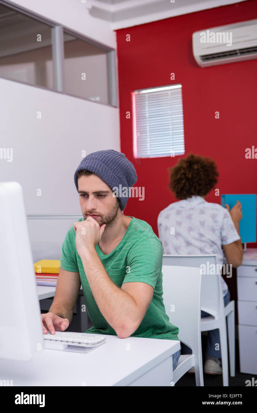 Concentrated casual businessman using computer in office Stock Photo ...