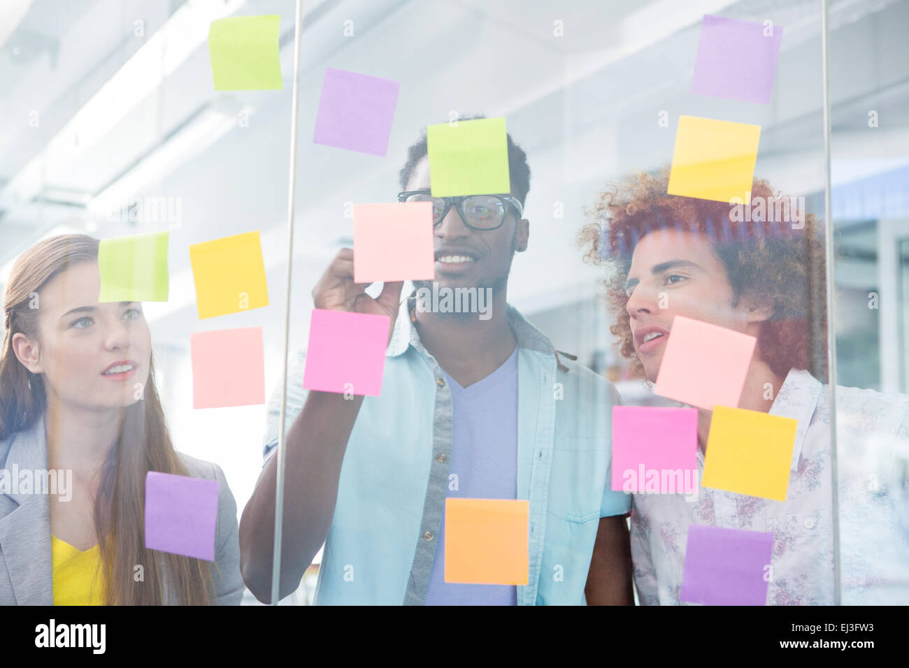 Creative team writing on adhesive notes Stock Photo - Alamy