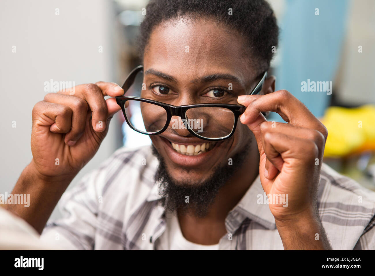 Happy male fashion designer holding eye glasses Stock Photo - Alamy