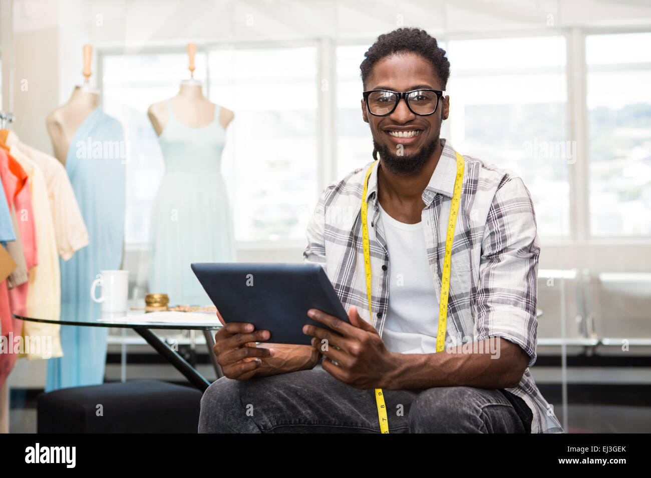 Confident male fashion designer with digital tablet Stock Photo - Alamy