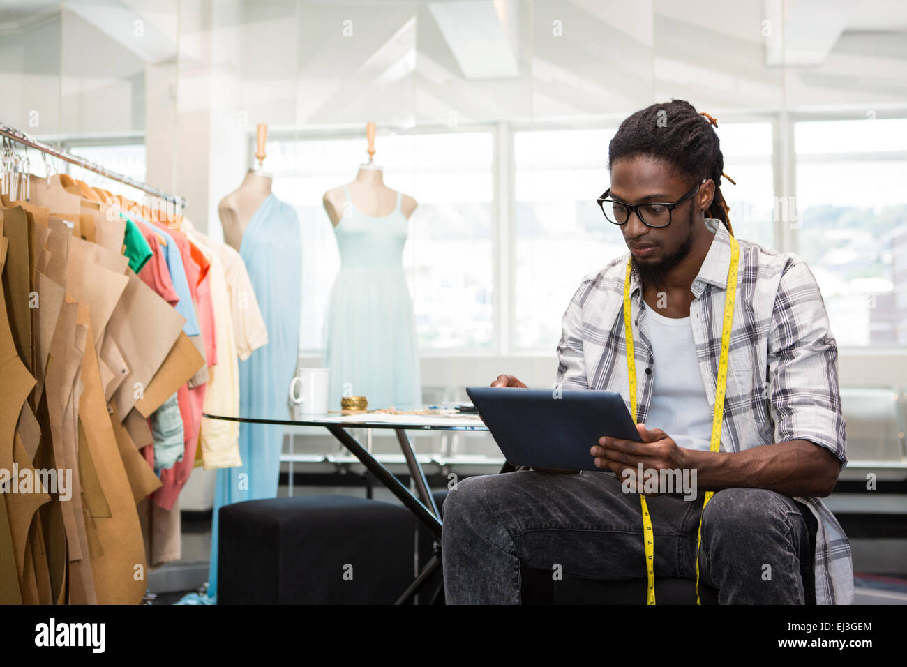 Fashion designer using digital tablet Stock Photo - Alamy