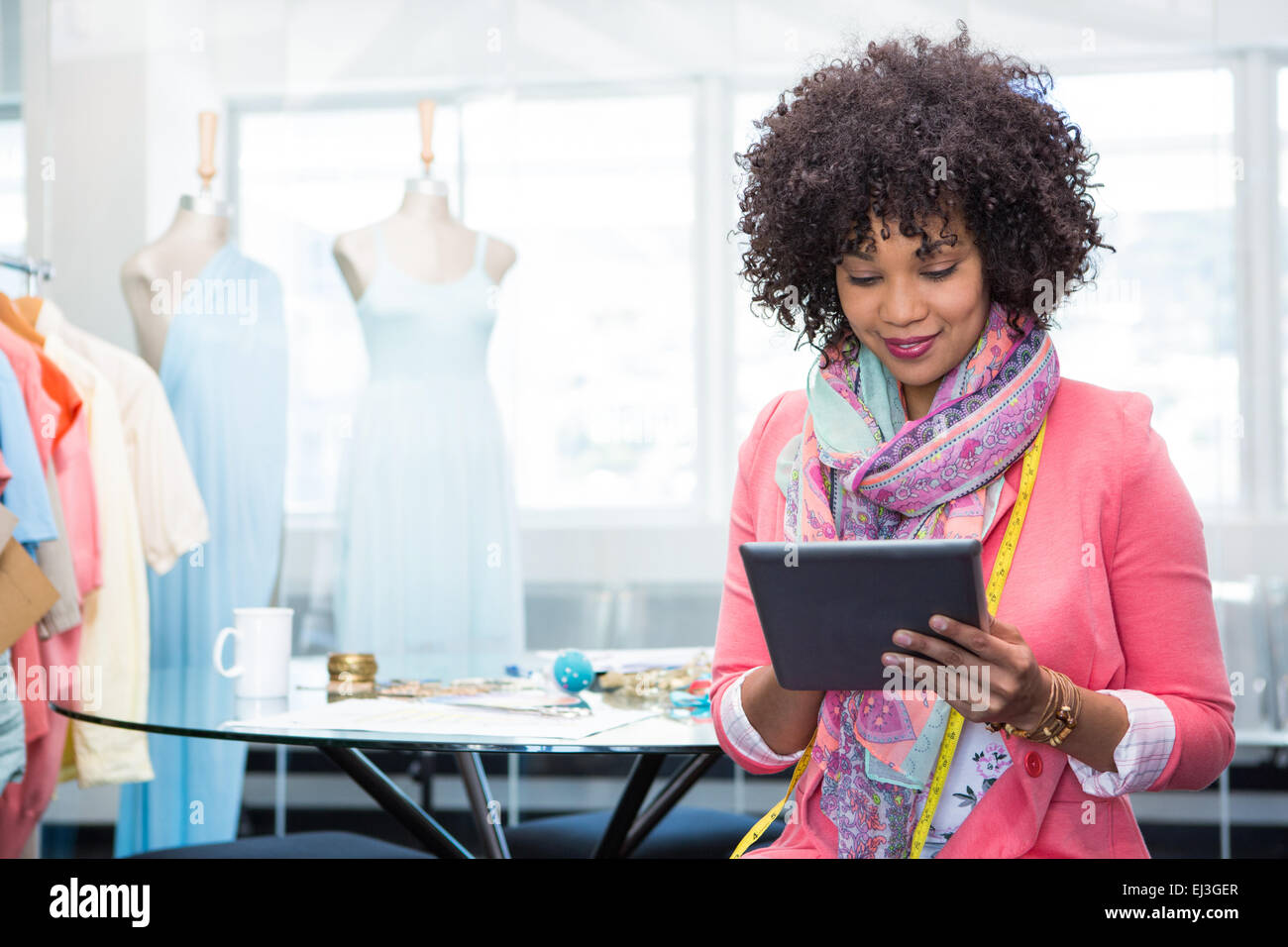 Female fashion designer using digital tablet Stock Photo - Alamy