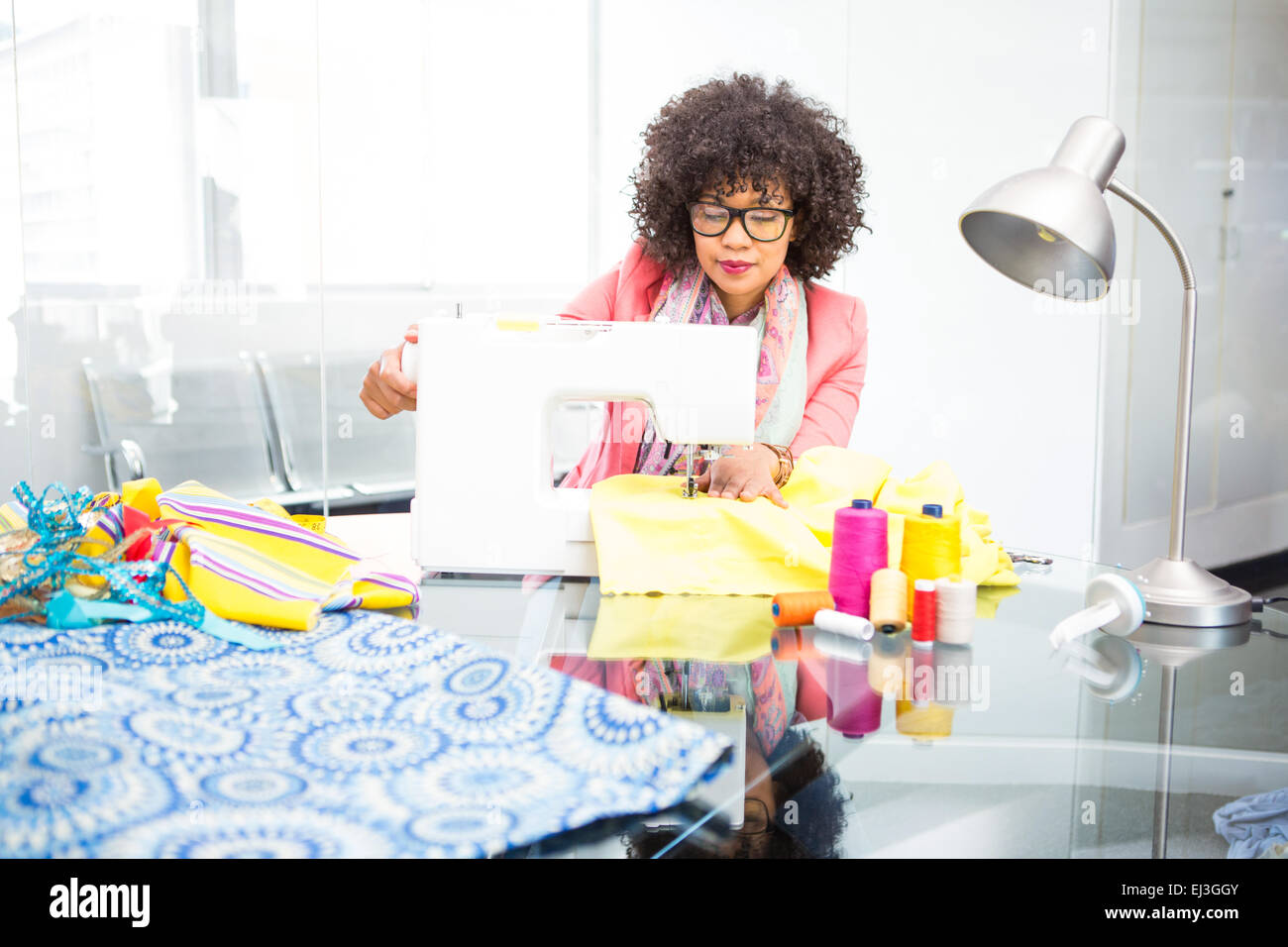 Fashion designer using sewing machine Stock Photo - Alamy