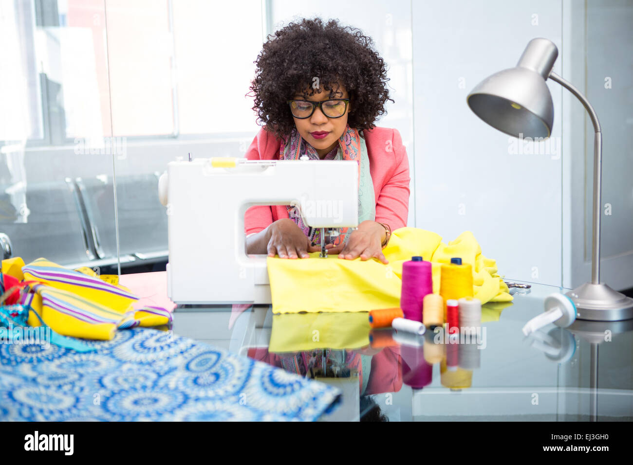 Fashion designer using sewing machine Stock Photo - Alamy