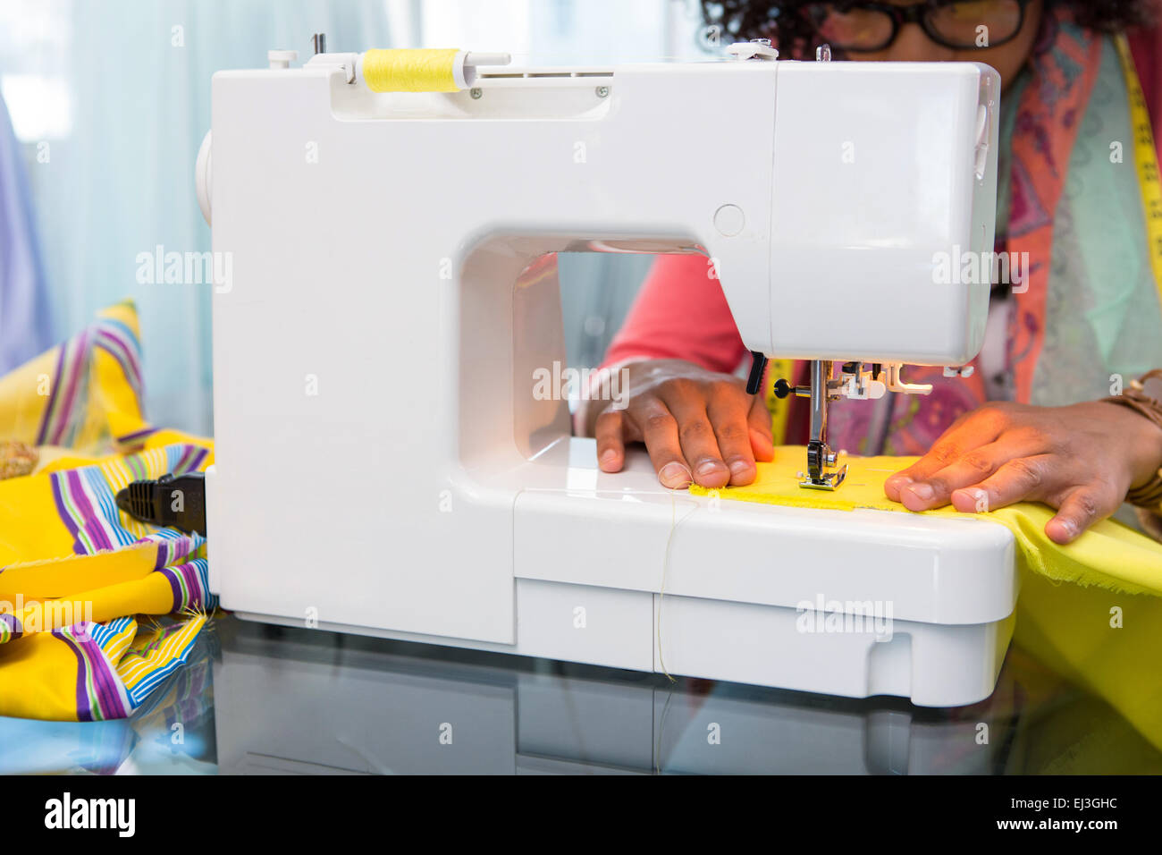 Fashion designer using sewing machine Stock Photo - Alamy