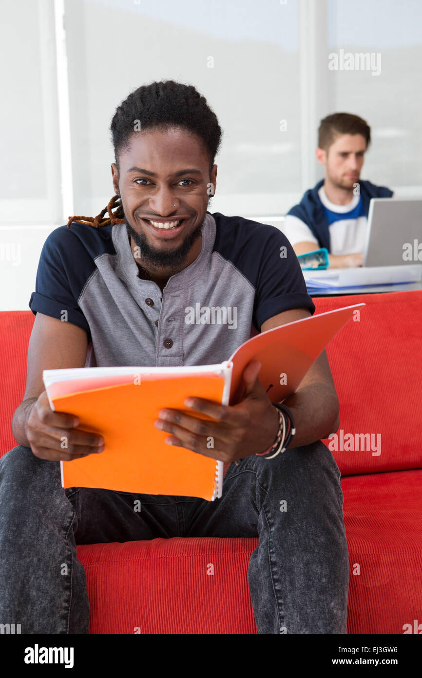 Creative young man reading documents hi-res stock photography and ...