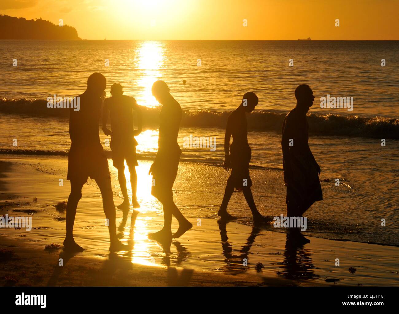 Silhouettes of people at sunset Stock Photo - Alamy