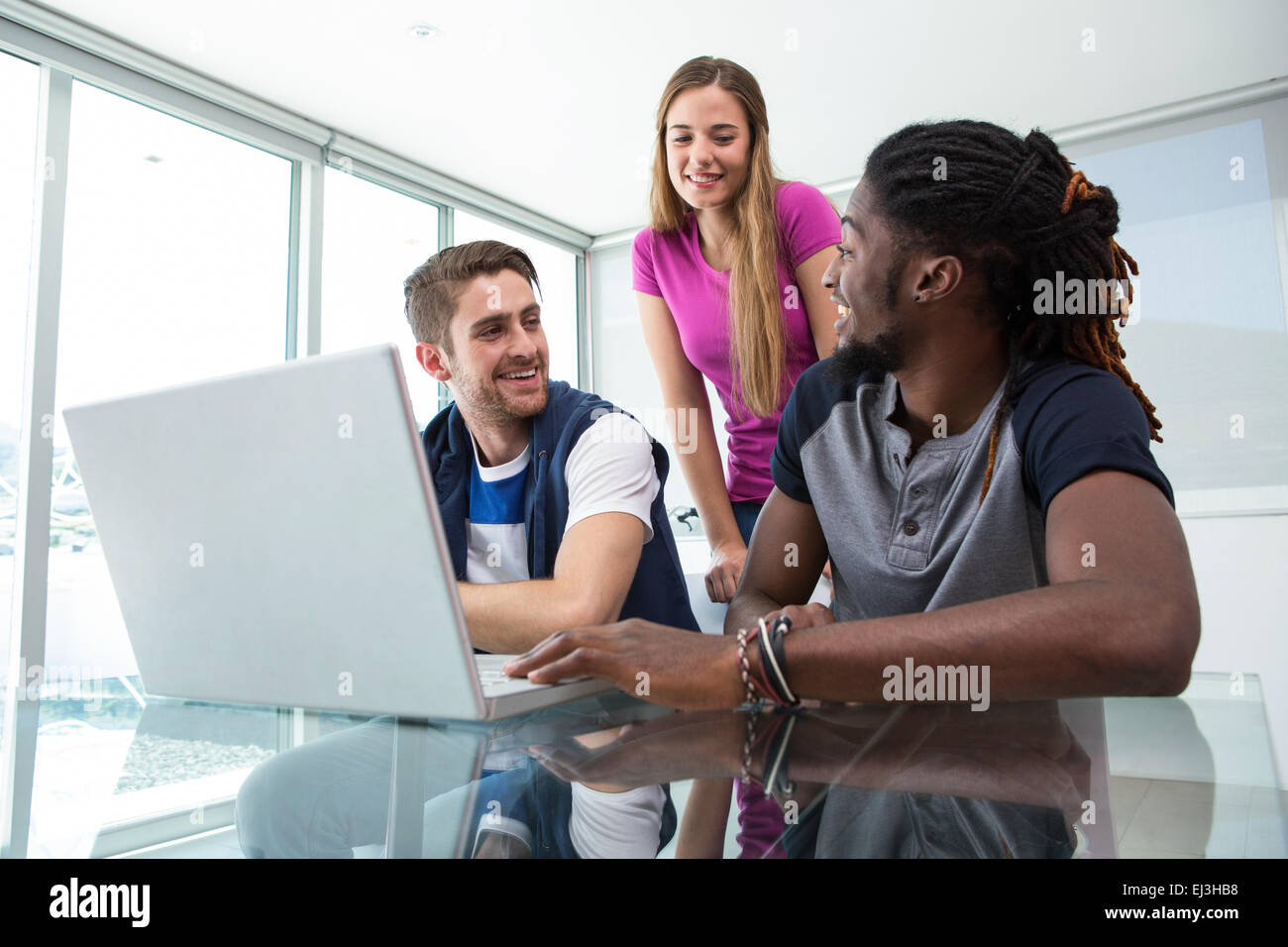 Creative team using laptop Stock Photo - Alamy