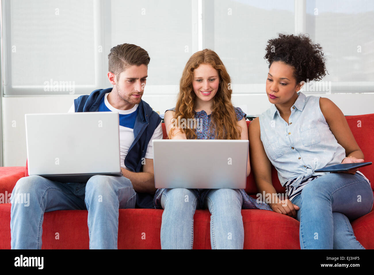 Creative team using laptops and digital tablet Stock Photo - Alamy