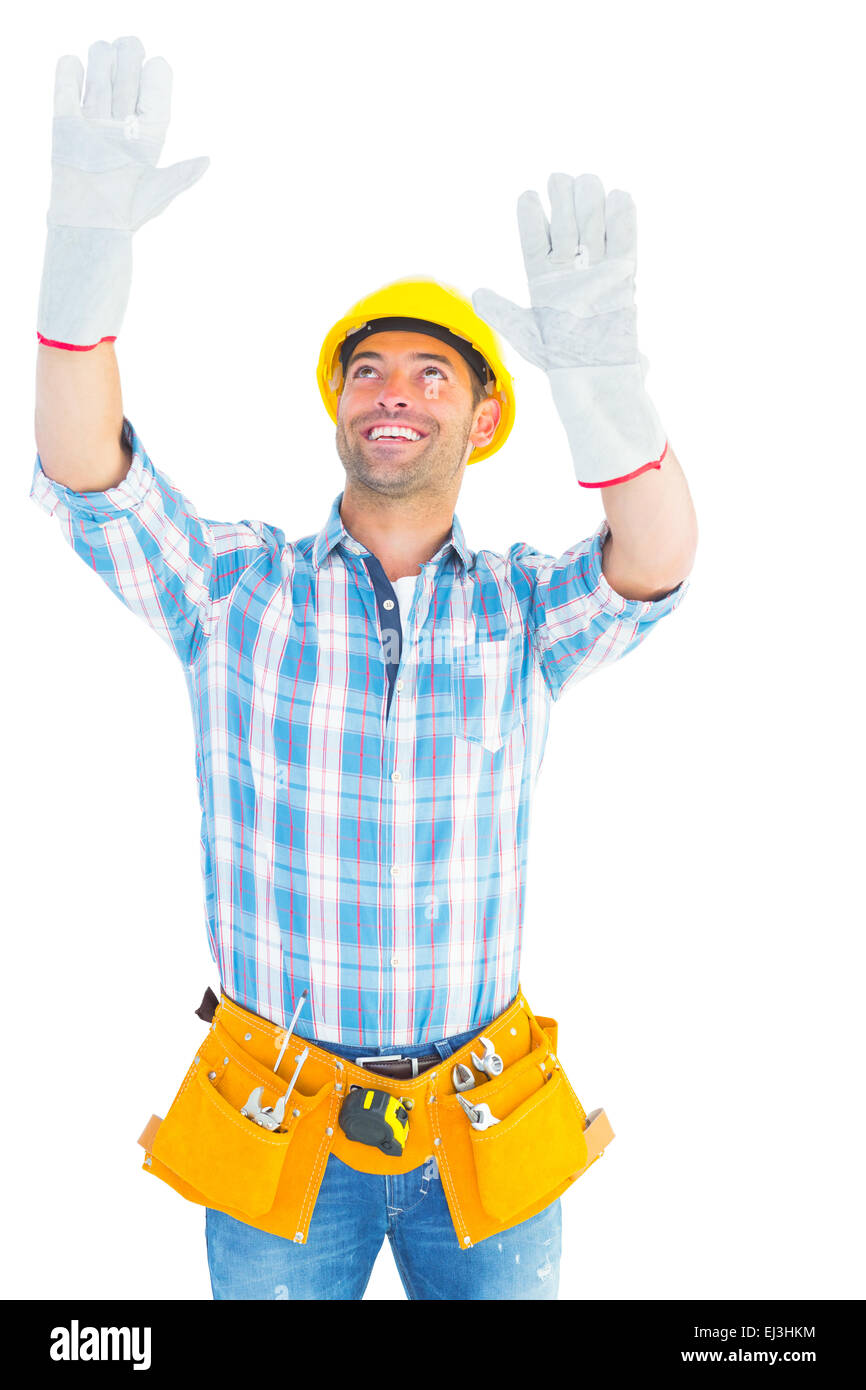 Manual worker raising hands while looking up Stock Photo - Alamy
