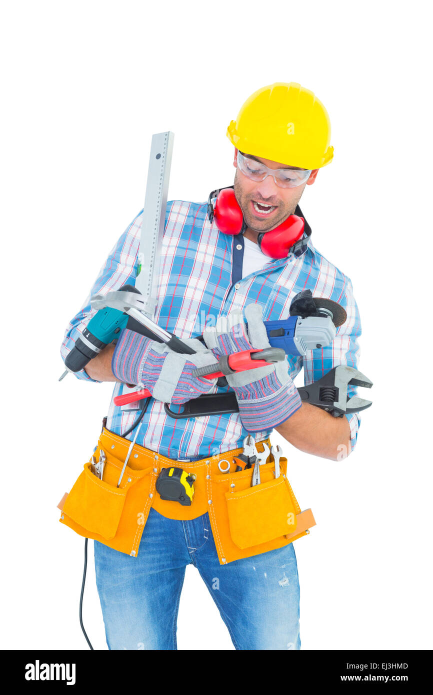 Manual worker balancing various tools Stock Photo - Alamy
