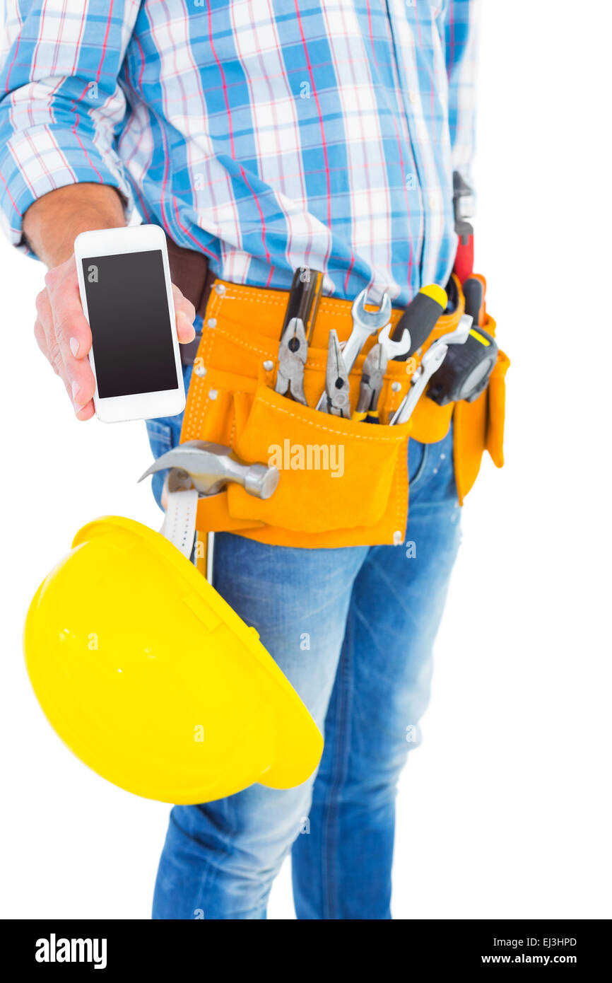 Midsection of handyman showing smartphone Stock Photo - Alamy