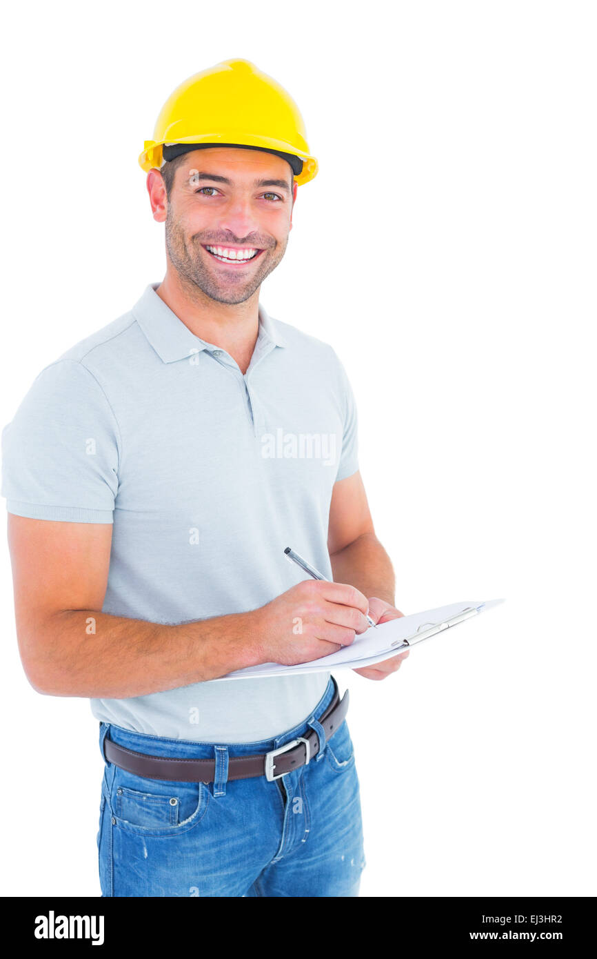 Portrait of smiling male supervisor writing on clipboard Stock Photo ...
