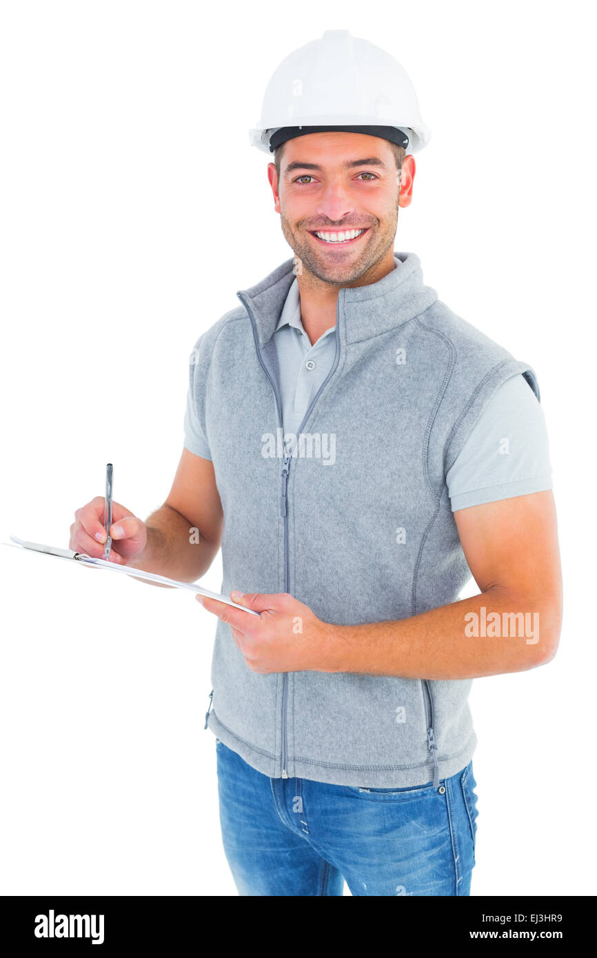 Portrait of smiling supervisor writing on clipboard Stock Photo - Alamy