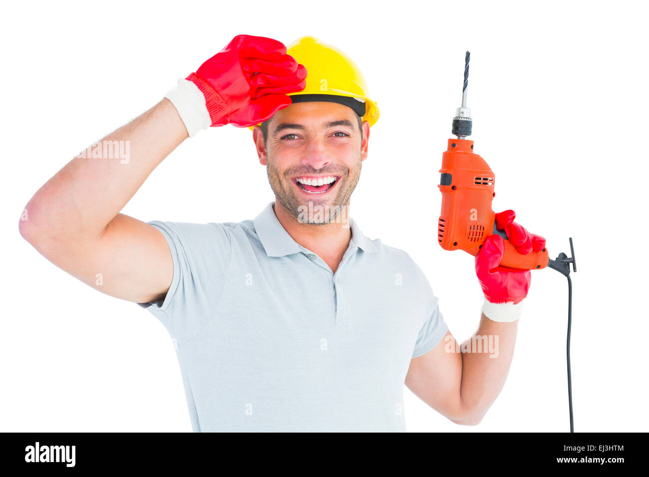 Smiling manual worker holding drill machine Stock Photo - Alamy