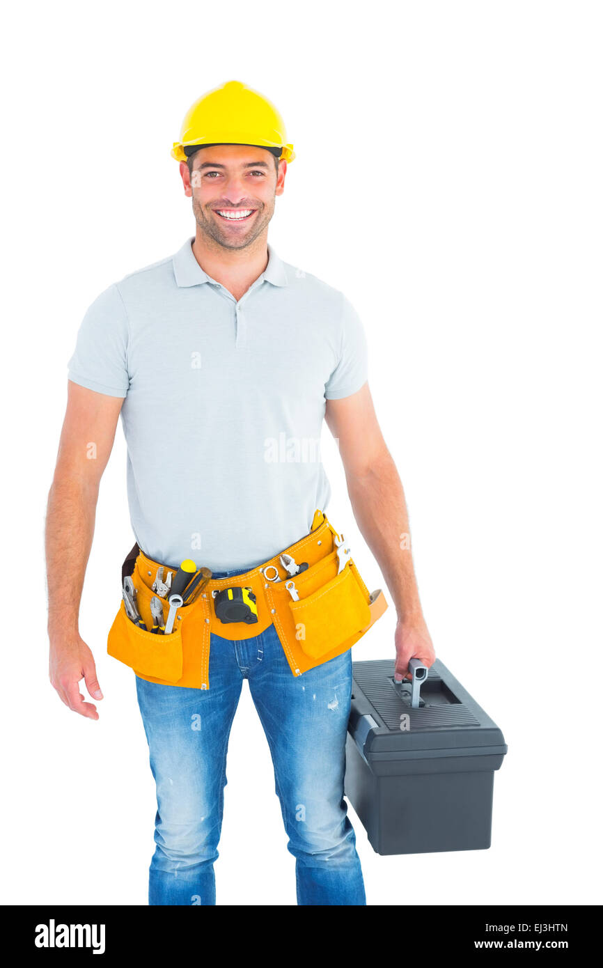 Portrait of smiling handyman holding toolbox Stock Photo - Alamy