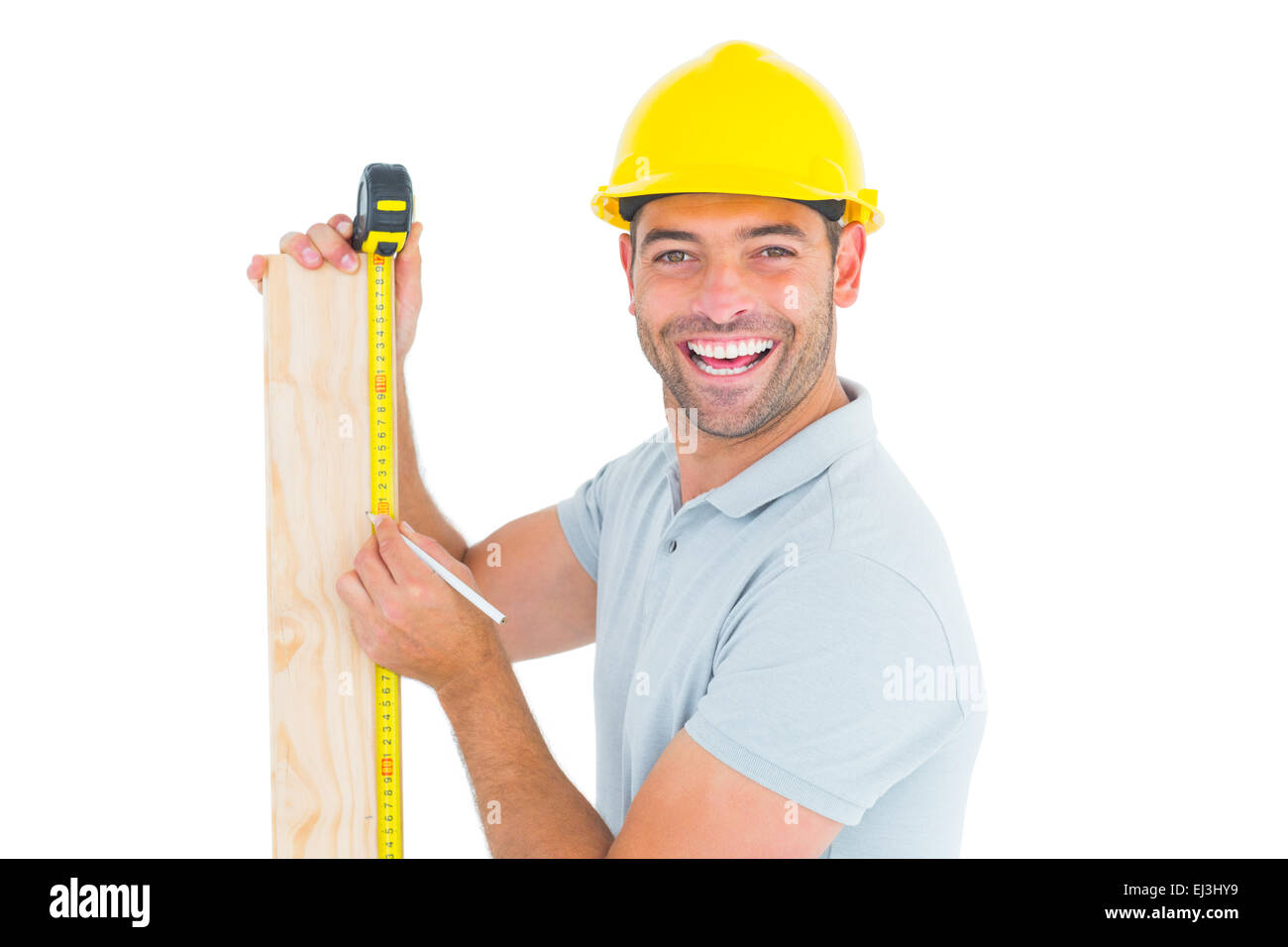Construction worker using measure tape to mark on plank Stock Photo - Alamy
