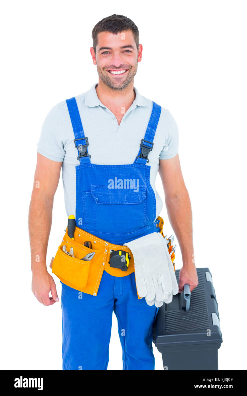 Happy workman in overalls holding toolbox Stock Photo - Alamy