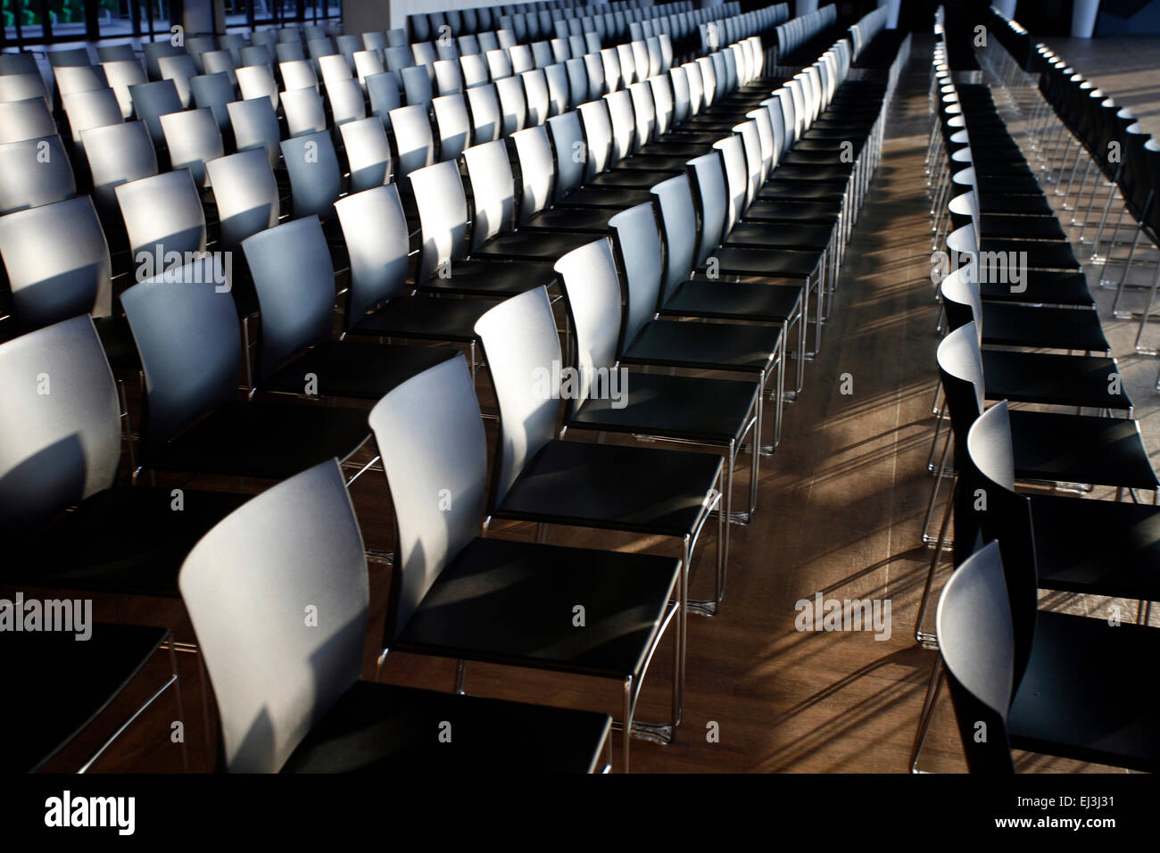 Rows of empty chairs prepared for an indoor event Stock Photo - Alamy