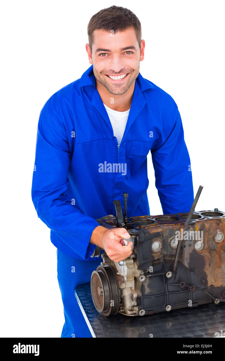 Smiling male machanic repairing car engine Stock Photo - Alamy