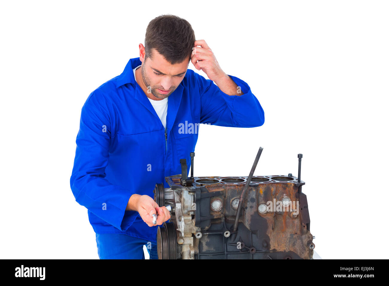 Confused mechanic repairing car engine Stock Photo - Alamy