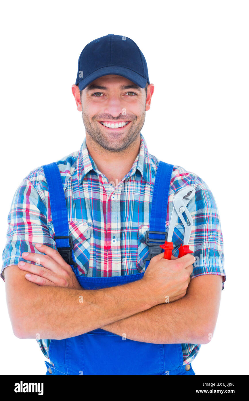 Happy repairman holding pliers on white background Stock Photo - Alamy