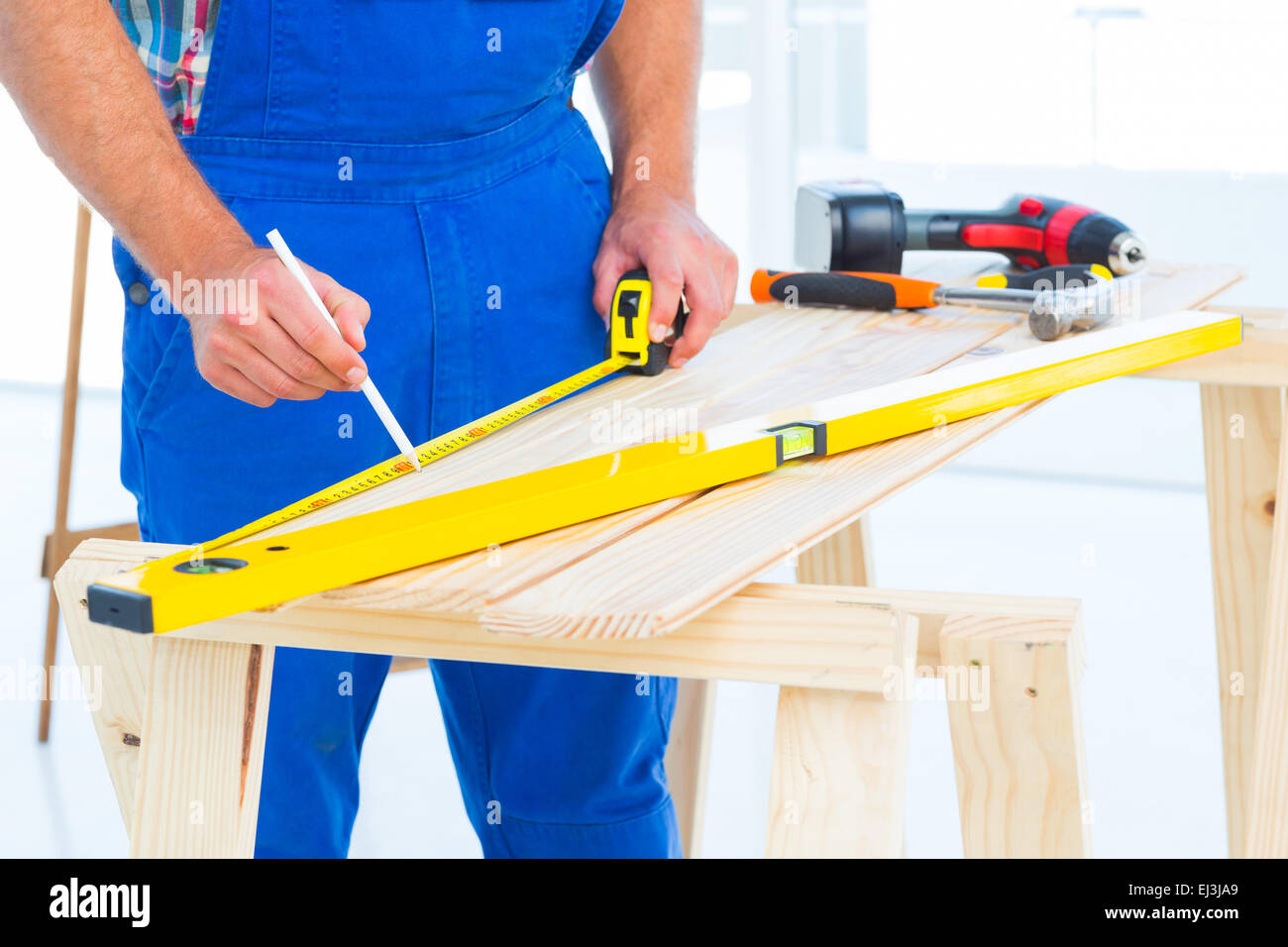 Carpenter working at workbench in office Stock Photo - Alamy
