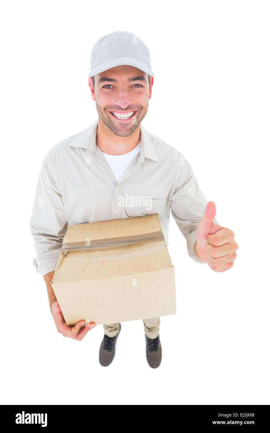 Handsome delivery man with cardboard box gesturing thumbs up Stock ...