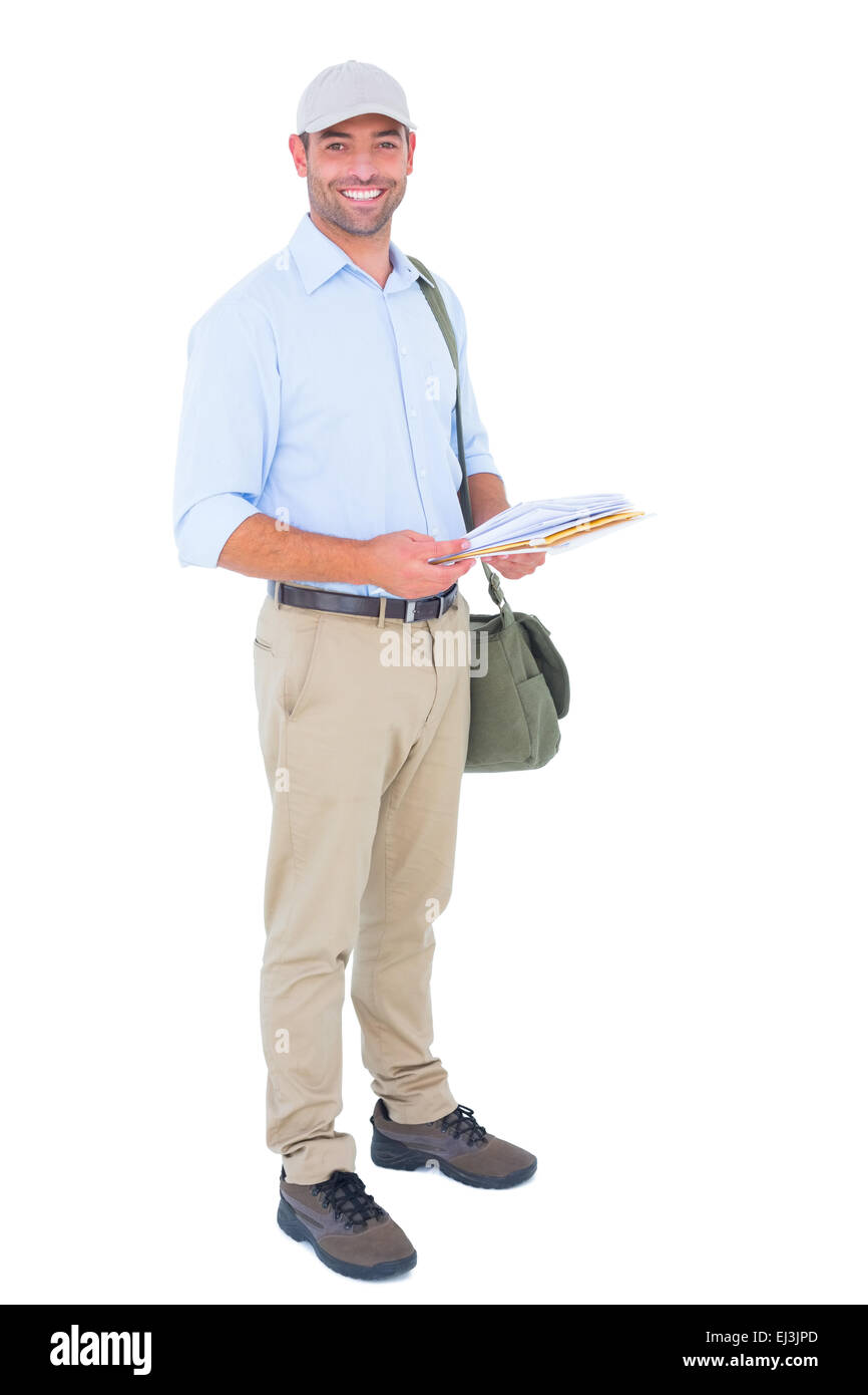 Full length portrait of happy postman with letters Stock Photo - Alamy