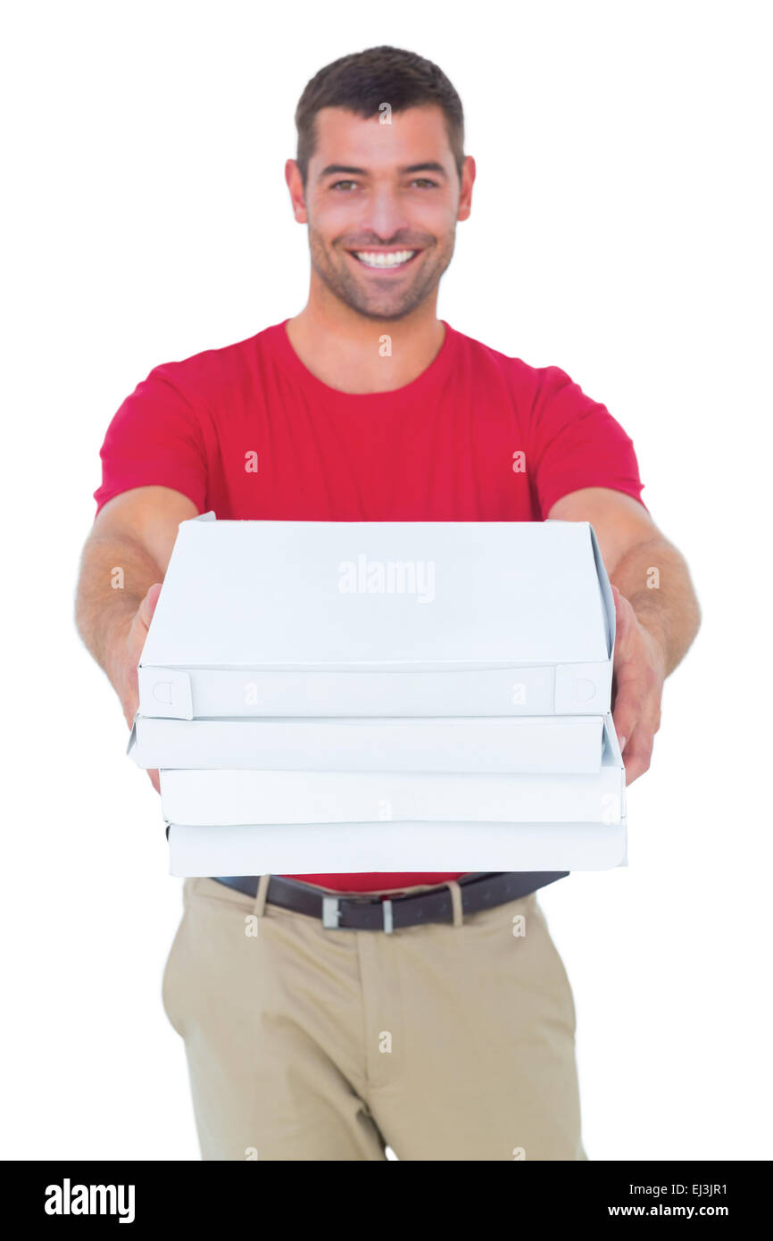 Happy delivery man giving pizza boxes Stock Photo - Alamy