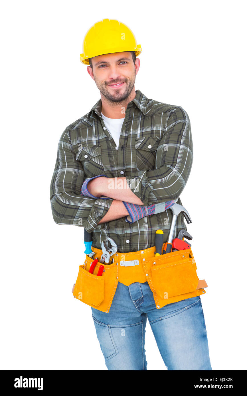 Smiling handyman wearing tool belt Stock Photo - Alamy