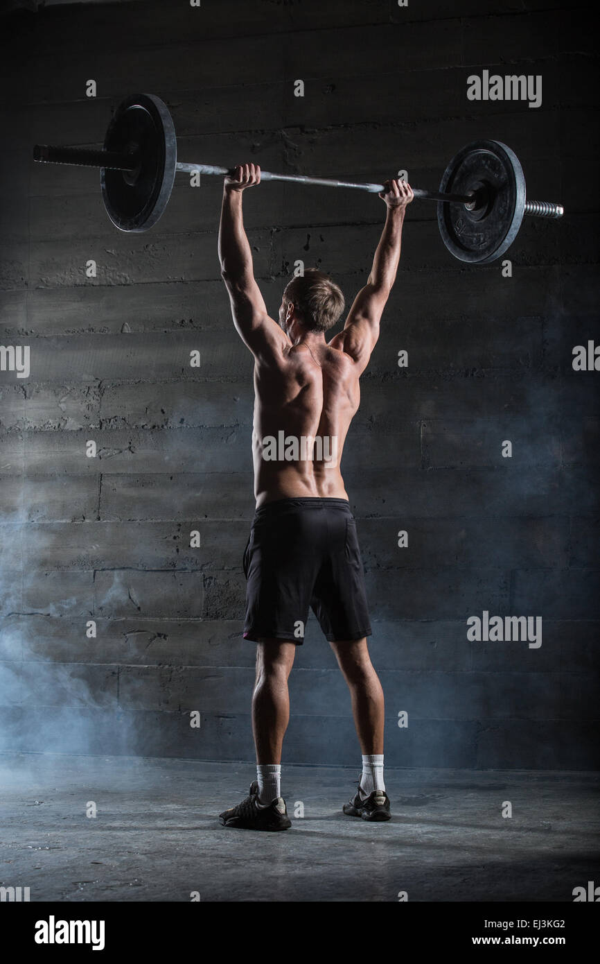 Athlete with barbell Stock Photo - Alamy