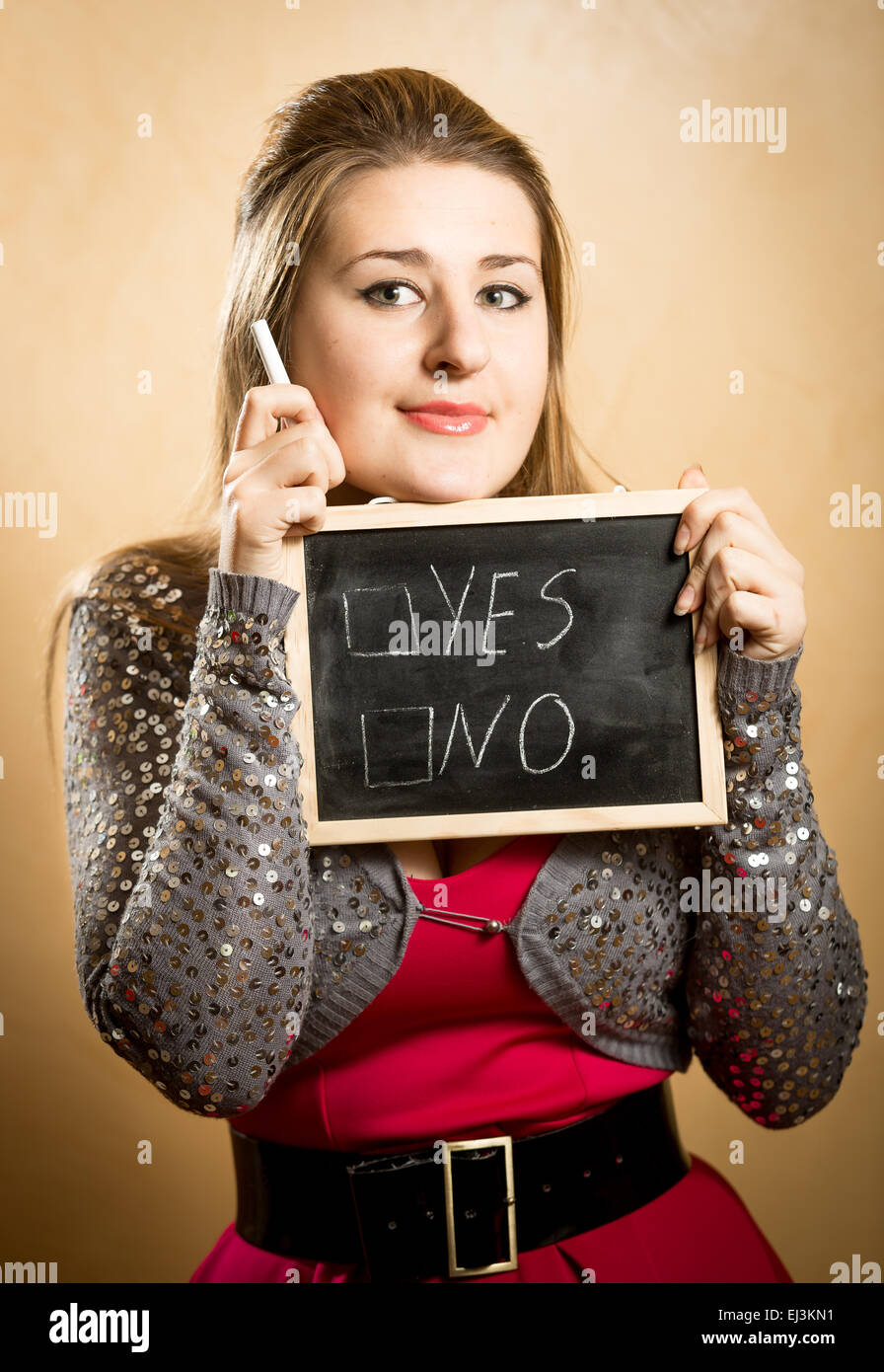 Portrait of smiling woman making decision on white chalkboard Stock ...