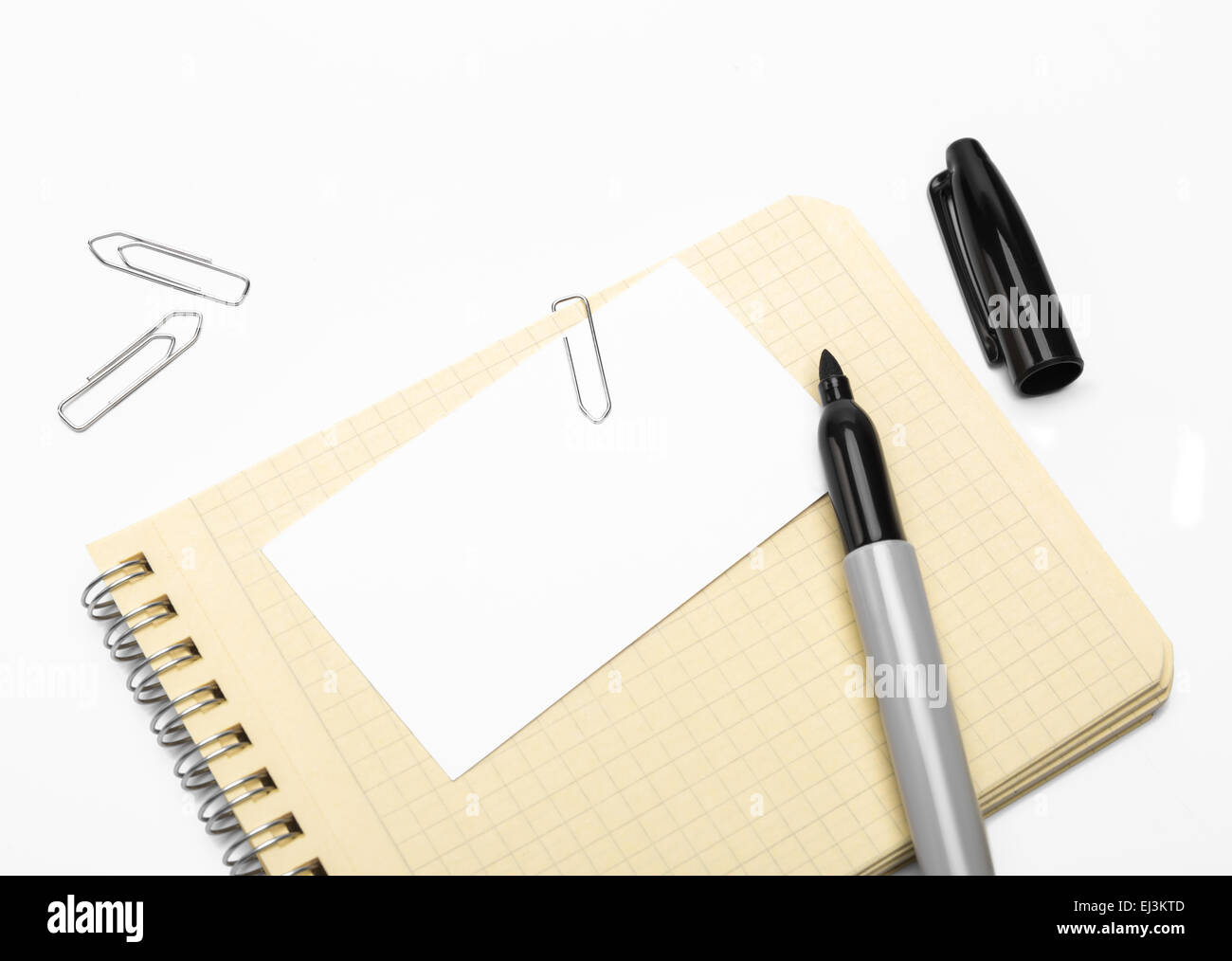 yellow notebook and marker and few clips on the white background Stock ...