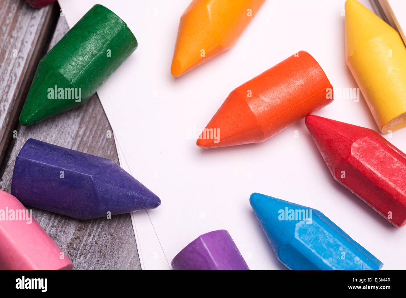 many colorful crayons scattered on a white paper sheets Stock Photo - Alamy