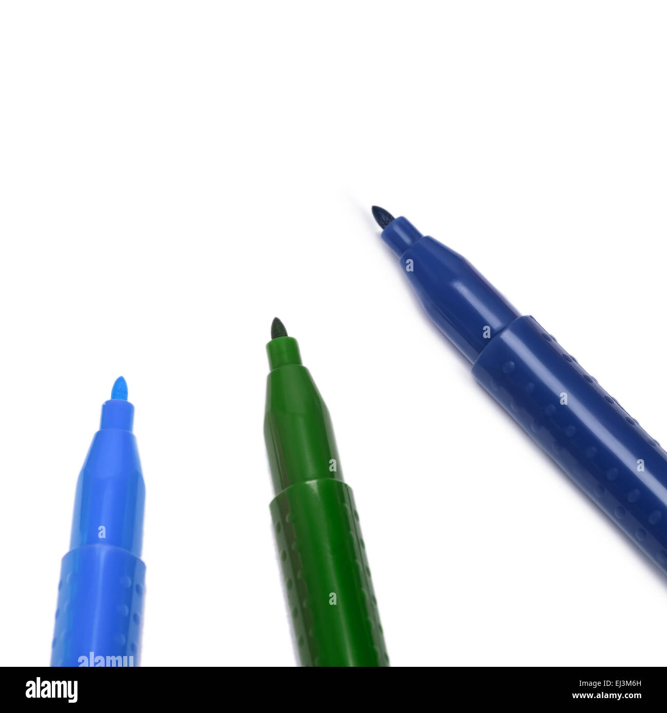 few colorful markers and their caps on white background Stock Photo - Alamy